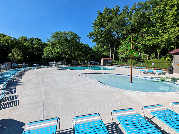 The swimming pool area provides a chlorinated alternative to lake swimming, with lounge chairs perfectly positioned for parental supervision.