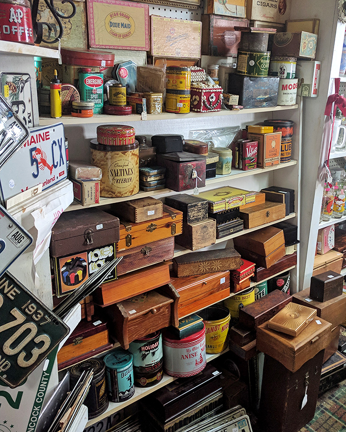 A collector's dream corner filled with vintage tins, wooden boxes, and advertising memorabilia &ndash; each shelf a time capsule of American consumer history.