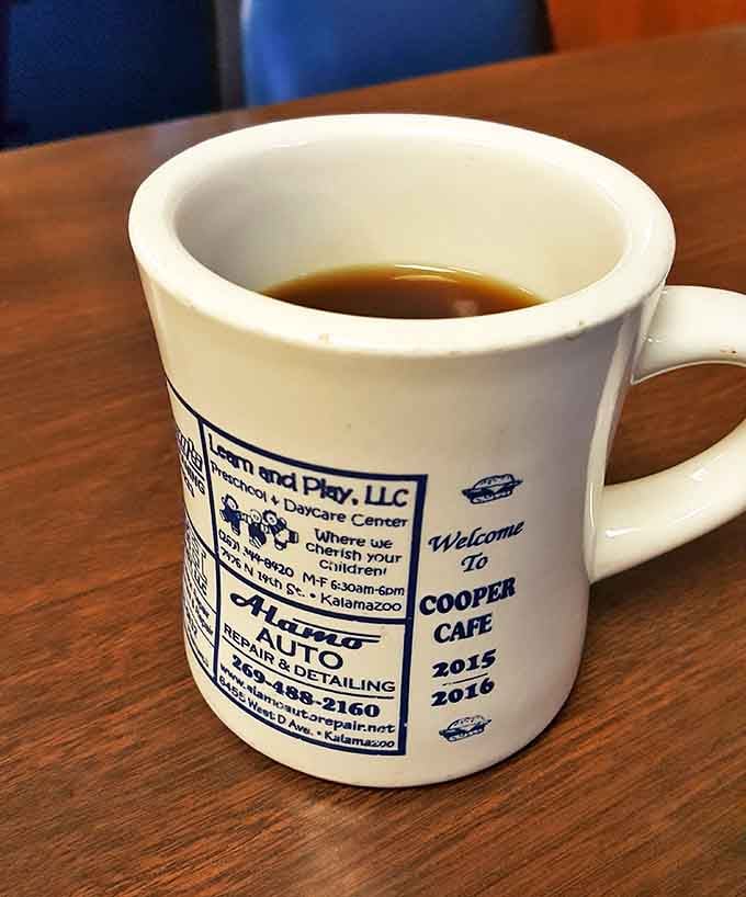 Coffee: The lifeblood of any respectable diner, served in a mug that doubles as local advertising &ndash; community support one sip at a time.