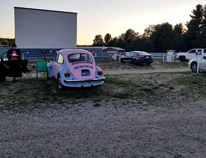 A classic pink Beetle adds vintage charm to the Cherry Bowl Drive-In Theatre experience, perfectly matching the retro vibe of outdoor cinema.