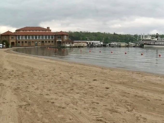 The sandy shore at Riviera Beach offers a perfect vantage point for watching boats glide across Geneva Lake's sparkling surface.