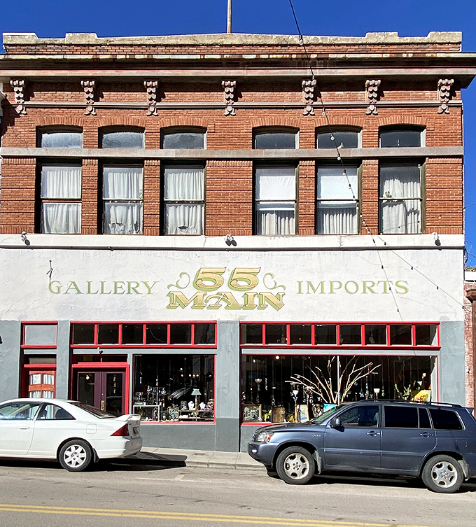 Gallery 55 Main showcases local artistry behind bright red window frames, tempting passersby to discover treasures they never knew they needed.