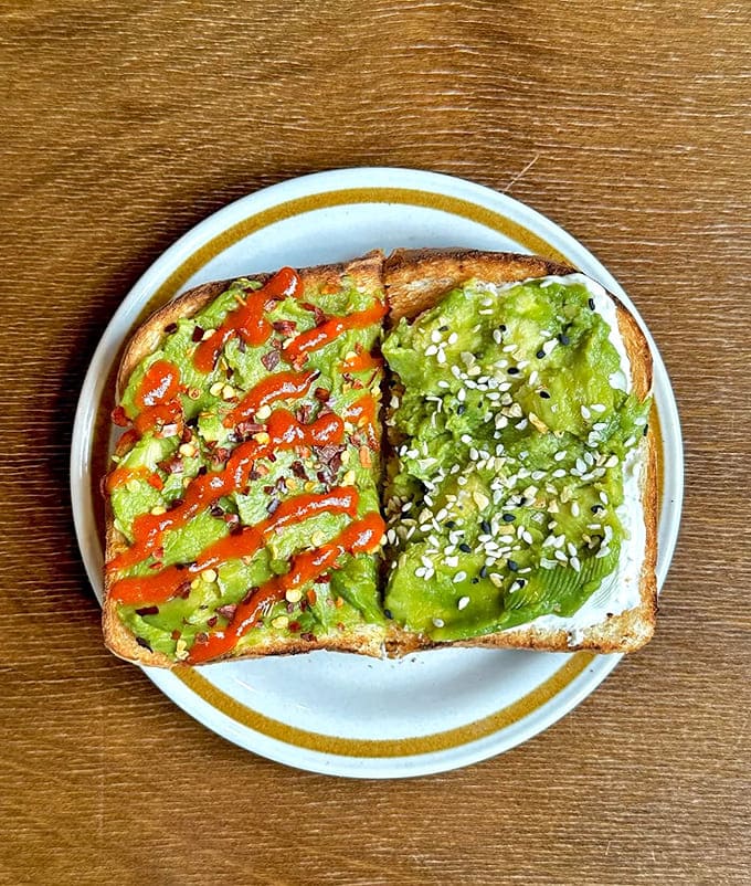 Avocado toast two ways: one with sriracha zigzags for heat seekers, one with sesame seeds for the purists &ndash; both equally Instagram-worthy.