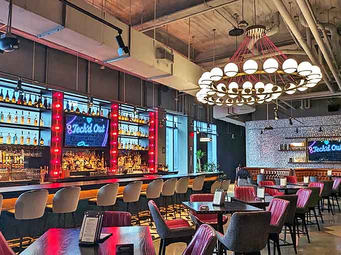 Between rounds, the sophisticated bar area offers a moment of respite with craft cocktails served under statement lighting that flatters everyone.