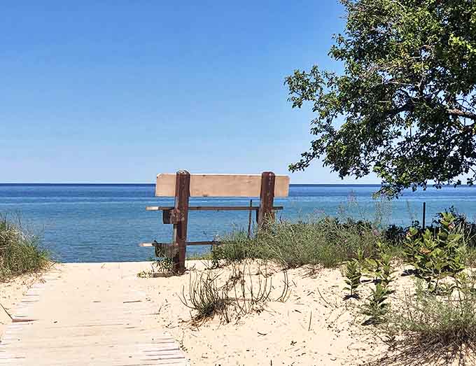 This simple wooden bench offers one of Michigan's most contemplative views, inviting visitors to sit awhile and watch Lake Huron's moods shift like a living painting.
