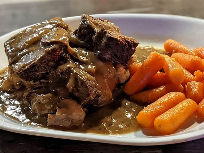 Pot roast so tender it barely needs a fork, swimming in rich gravy with carrots that actually taste like vegetables.