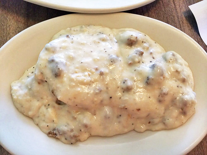 Biscuits drowning in creamy sausage gravy deliver the kind of comfort that makes you understand why people write songs about Southern cooking.