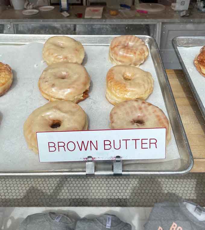 Brown butter glaze on fresh donuts creates that nutty, caramelized flavor that tastes like autumn feels.