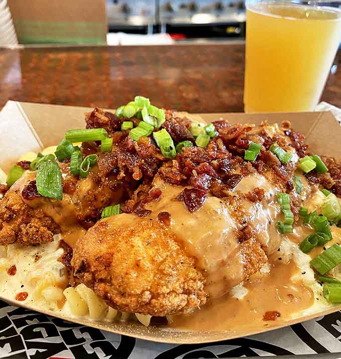 Mac and cheese topped with chicken and bacon – comfort food that's gotten a promotion and corner office.