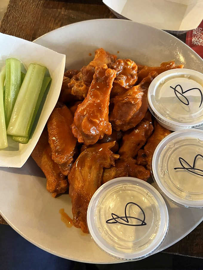 The platonic ideal of buffalo wings! That vibrant orange sauce clings lovingly to each wing, promising flavor fireworks with every bite.