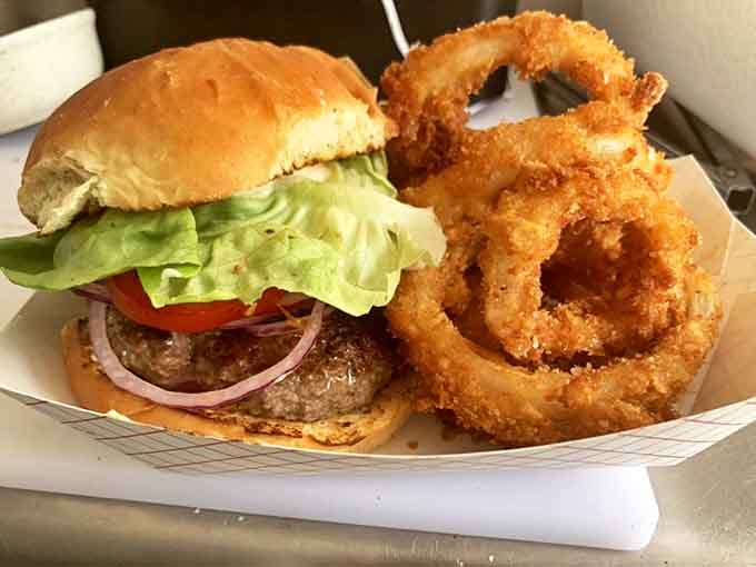 This classic burger with golden onion rings proves that sometimes the simplest combinations create the most magical results.