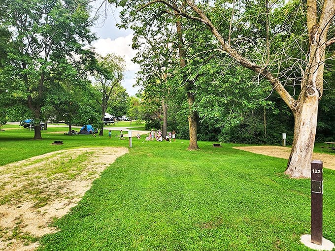 Campsites spread across manicured lawns, each one a temporary neighborhood where strangers become friends over shared sunsets and campfire stories.