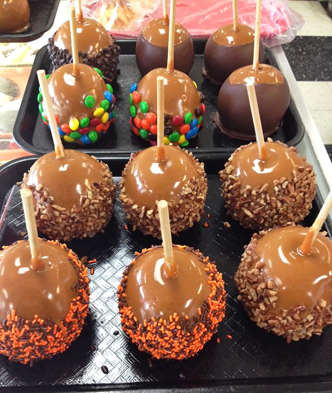 Caramel apples elevated to jewelry status &ndash; glossy, perfectly coated, and adorned with everything from colorful candies to nuts and chocolate chips.
