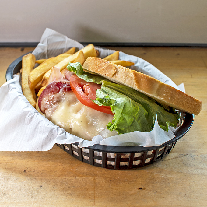 A chicken sandwich accompanied by fries like the world's most supportive friends, all of which are crispy and utterly delicious every time.