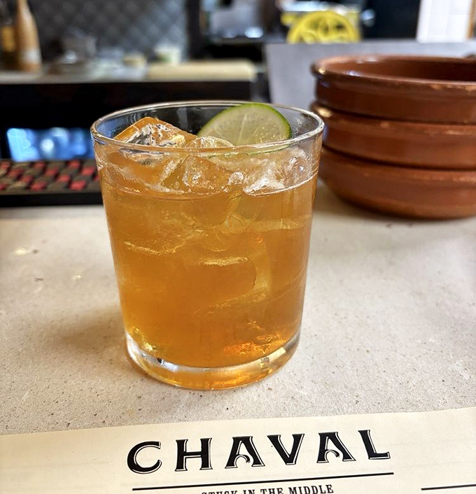 A perfectly balanced cocktail catches the light, promising complex flavors that will complement rather than compete with your meal.