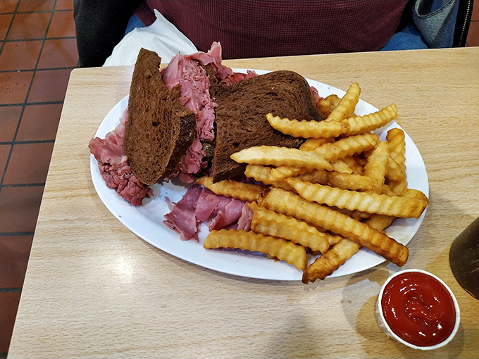 This isn't just a sandwich – it's a monument to beef, piled high between slices of rye that somehow support this magnificent tower of flavor.