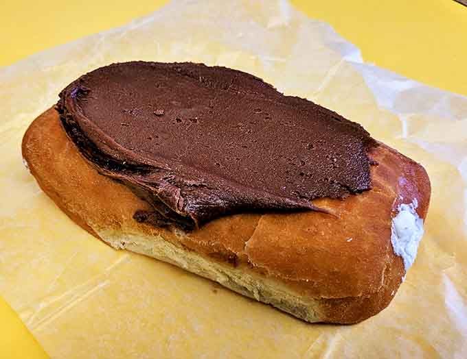 The chocolate long john &ndash; where rich frosting meets creamy filling in a relationship more perfect than most Hollywood marriages.