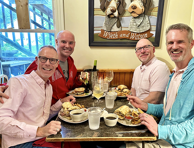 Happy diners enjoying what might be the best meal of their Vermont adventure. That dog portrait watching over them is priceless!
