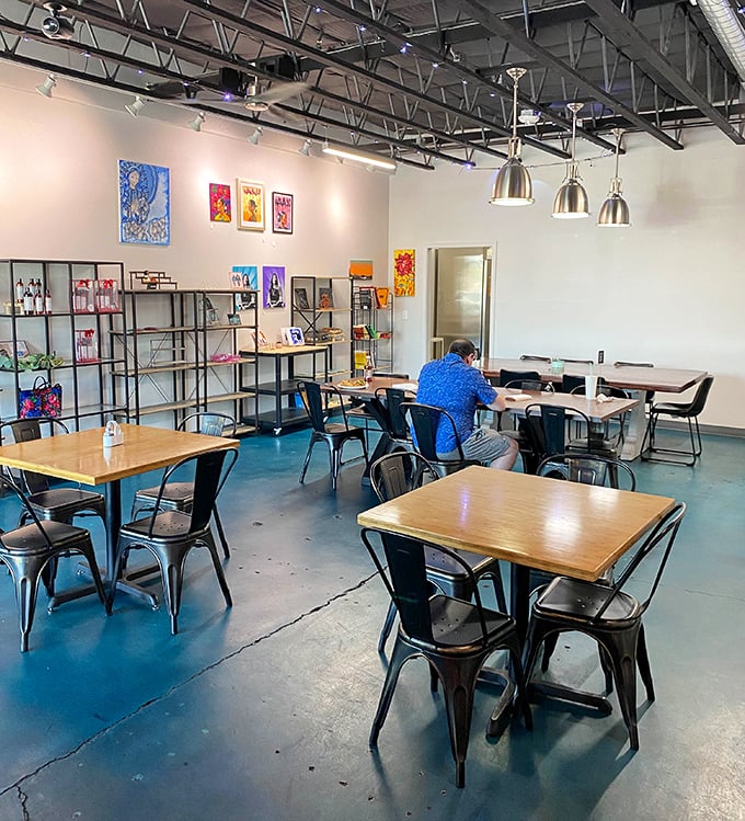 Modern minimalism meets artistic expression in the dining area, where local artwork adds splashes of color to the neutral palette.