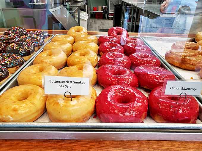 The display case &ndash; where donut dreams come to life and diet resolutions go to die, all under the warm glow of bakery lights.