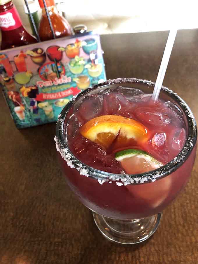 This sangria margarita looks like a sunset in a glass and tastes like vacation feels, minus the airport hassle.