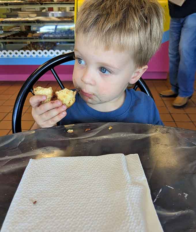 This young connoisseur knows quality when he tastes it, savoring every crumb like it's the last donut on earth.