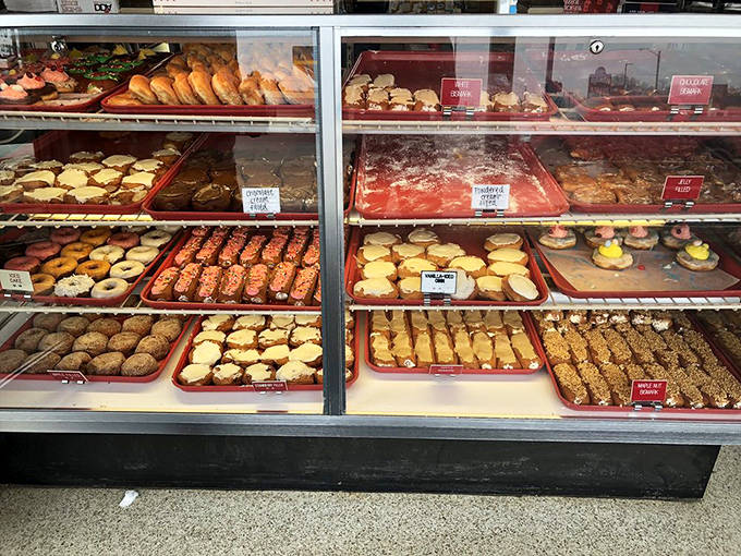 The display case at Crispie Creme is like a museum of donut artistry, where each variety has earned its place through decades of perfection.