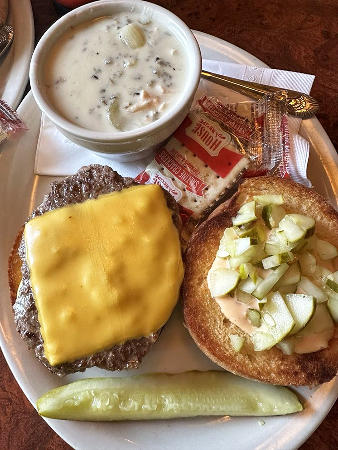 A cheeseburger that makes you wonder if you've been eating burgers wrong your whole life. The pickle stands guard like a delicious sentinel.