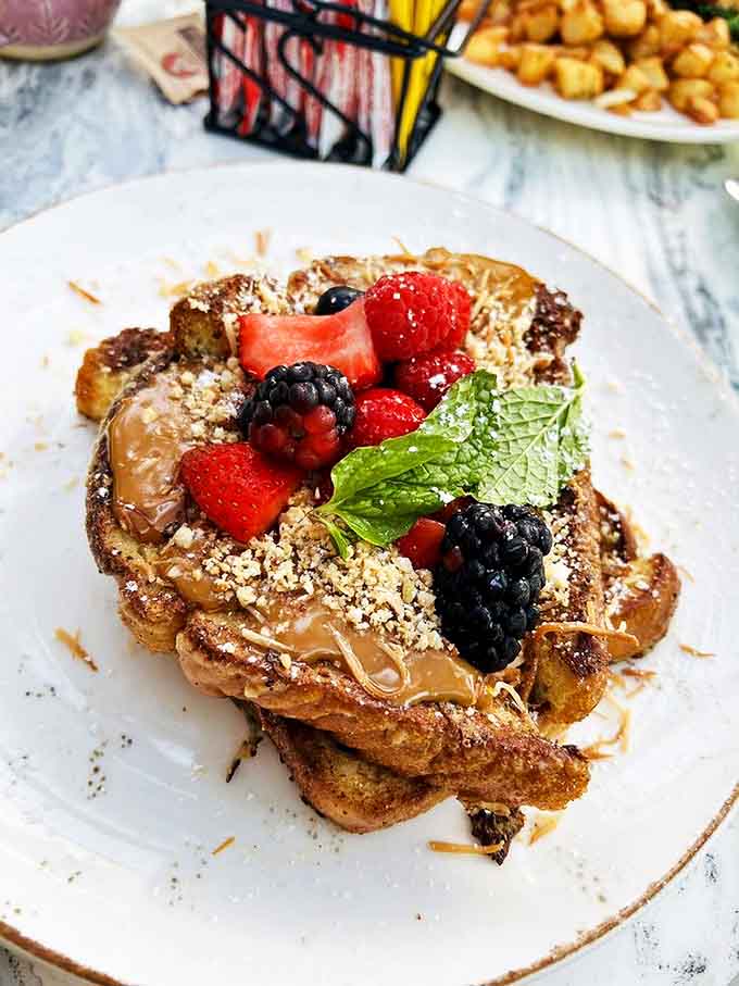 French toast that makes you question all other French toast &ndash; caramelized edges, fresh berries, and what looks like dulce de leche create breakfast nirvana.