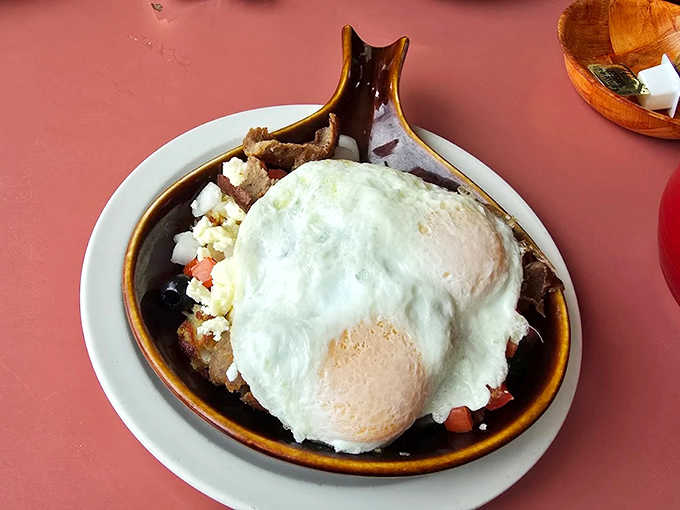A beautiful mess of breakfast favorites, crowned with eggs that look like they're auditioning for a food magazine cover shoot.