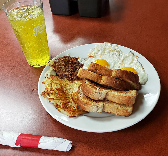 Morning glory on a plate: perfectly cooked eggs, golden toast, and hash browns with that ideal crispy-to-soft ratio that defines breakfast perfection.