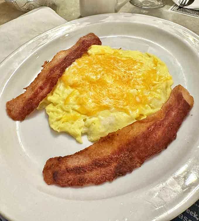 Breakfast simplicity at its finest &ndash; fluffy scrambled eggs with cheese and bacon cooked to that perfect crisp-yet-chewy consistency.