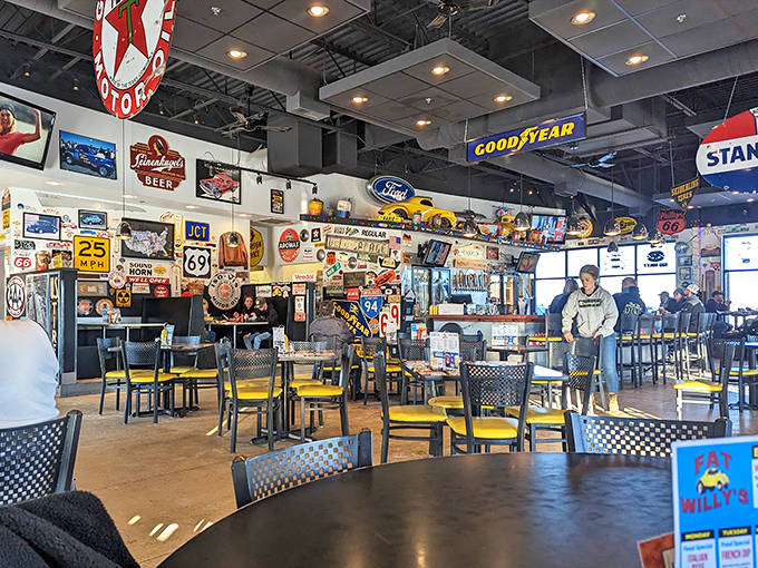 The dining area buzzes with energy as vintage road signs and automotive memorabilia create a museum-like backdrop for casual family gatherings.