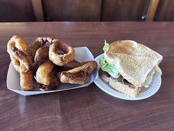 Another angle of sandwich perfection paired with crispy onion rings, a match made in tavern heaven.