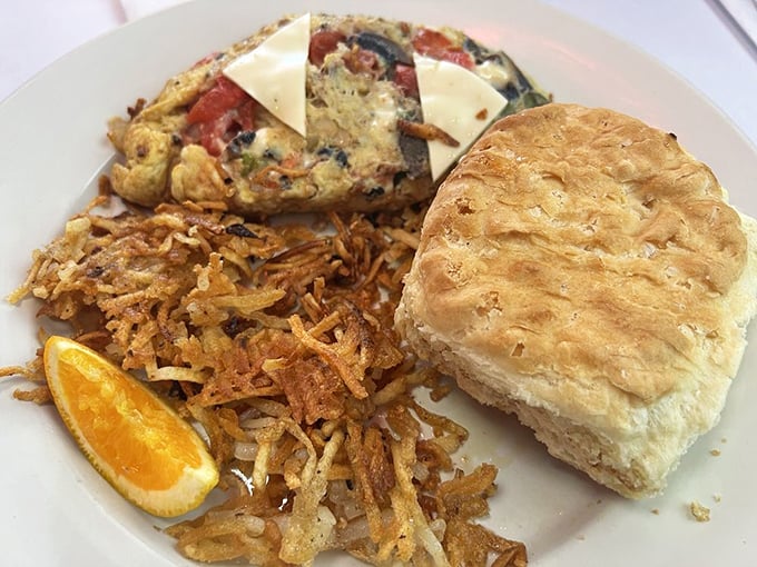 A fluffy egg blanket wrapped around garden-fresh veggies with a biscuit so flaky it should come with a warning label.