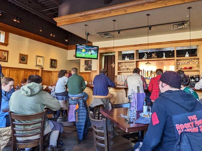 The bar area buzzes with conversation as locals and visitors alike gather to enjoy craft beers and exceptional pub fare.