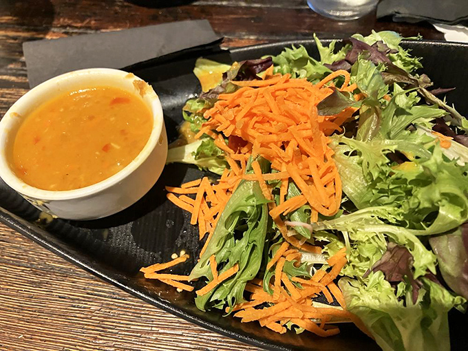 Crisp greens and shredded carrots swimming alongside a sunset-colored dressing that wakes up every taste bud in town.