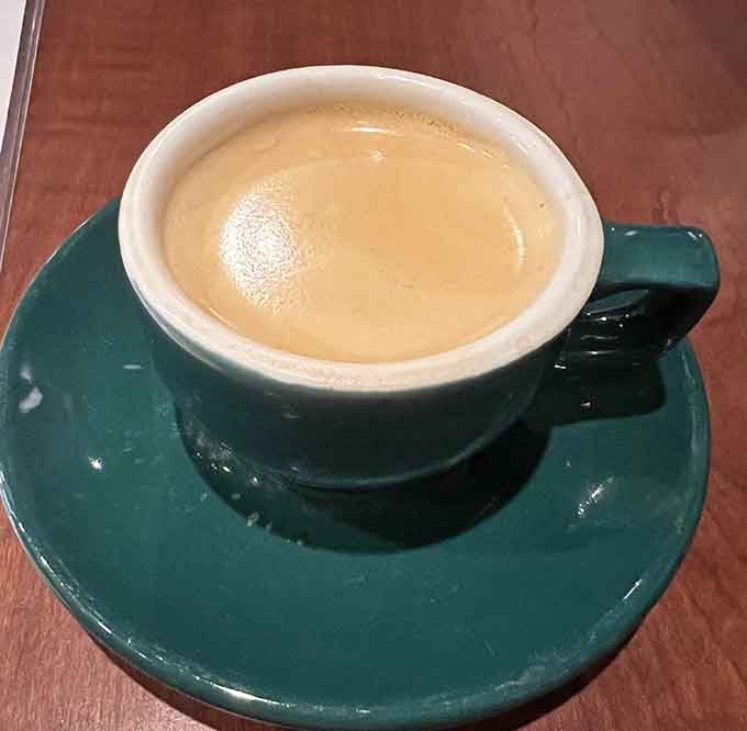 Properly pulled espresso in a cheerful cup, delivering that caffeine kick with the smoothness that only quality beans and skill can provide.