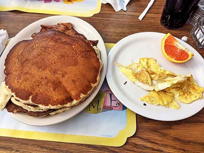 Pancakes so massive they deserve their own zip code, perfectly golden and ready to soak up rivers of real maple syrup.