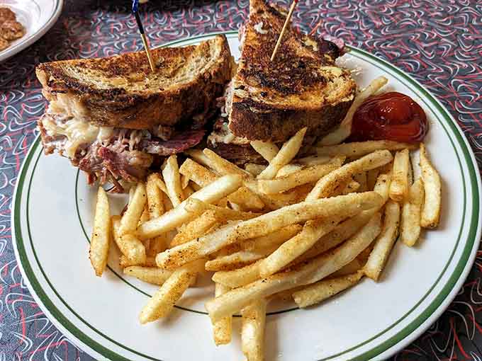 That pastrami sandwich stacked high on toasted bread looks like it requires an engineering degree to eat.