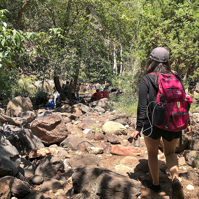 The final approach: Hikers navigate the rocky trail with the promise of cool waters ahead &ndash; motivation in its purest form.