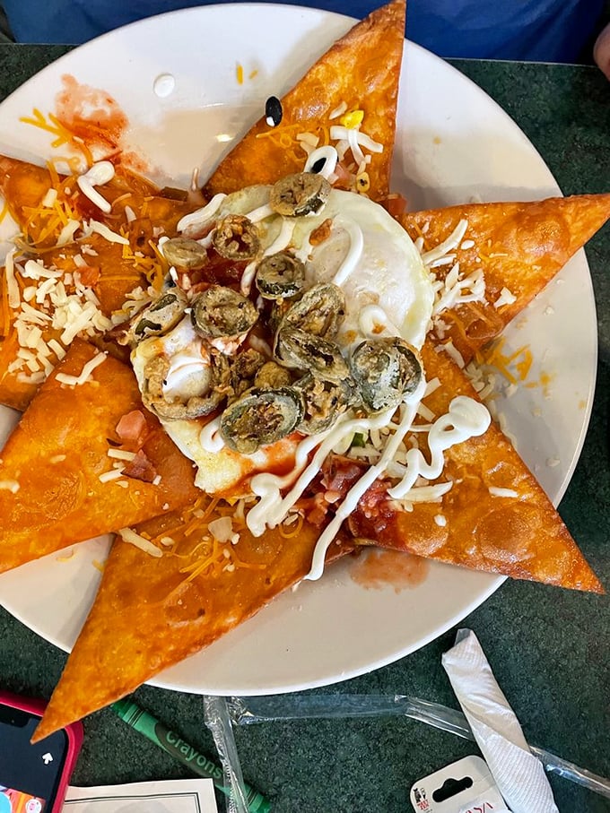 A star-shaped tortilla chip foundation topped with beans, cheese, eggs, and enough flavor to wake up your taste buds and your neighbors.