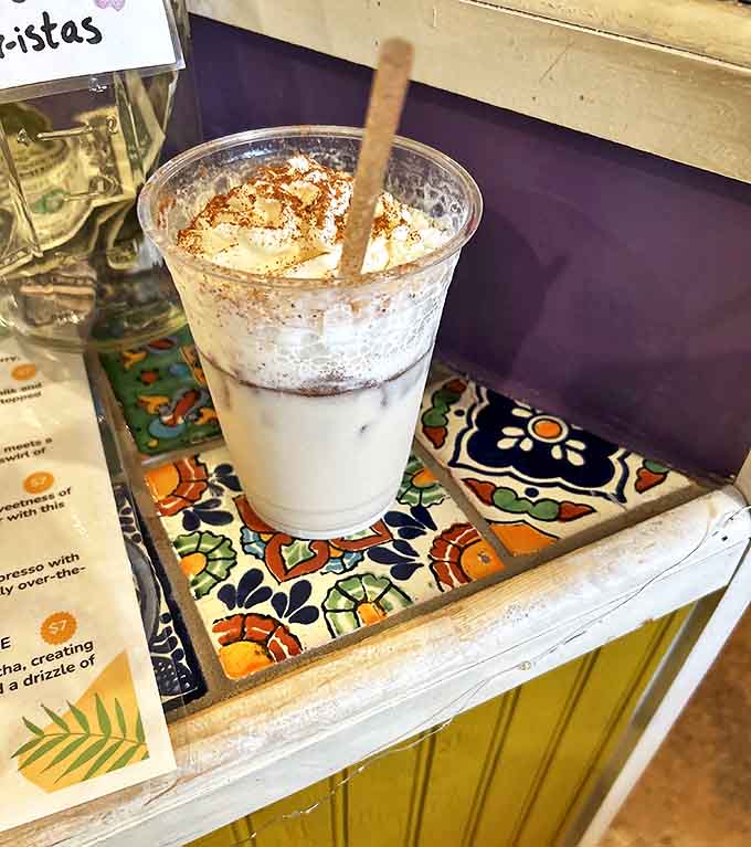 This iced chai latte, dusted with cinnamon and served with a biodegradable straw, offers refreshment between cat-petting sessions.