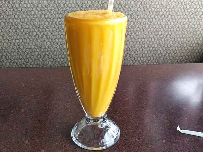 A mango lassi so thick and creamy it's practically a dessert, providing sweet relief when you've been a bit too ambitious with the spice level.