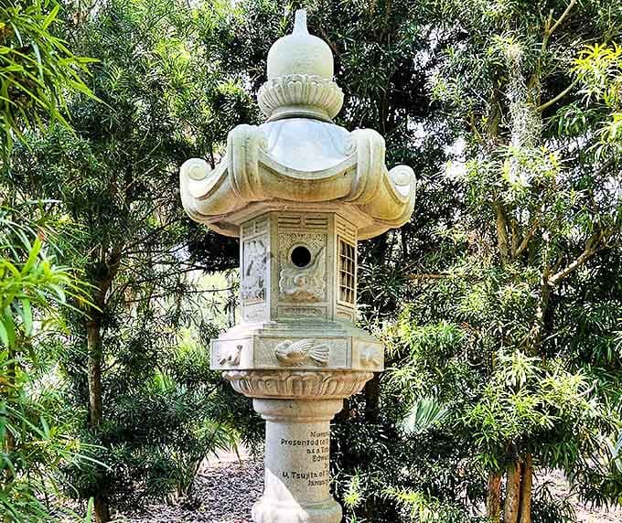This stone Japanese lantern stands sentinel among bamboo groves, a gift of peace that bridges Eastern tranquility with Florida's lush landscape.