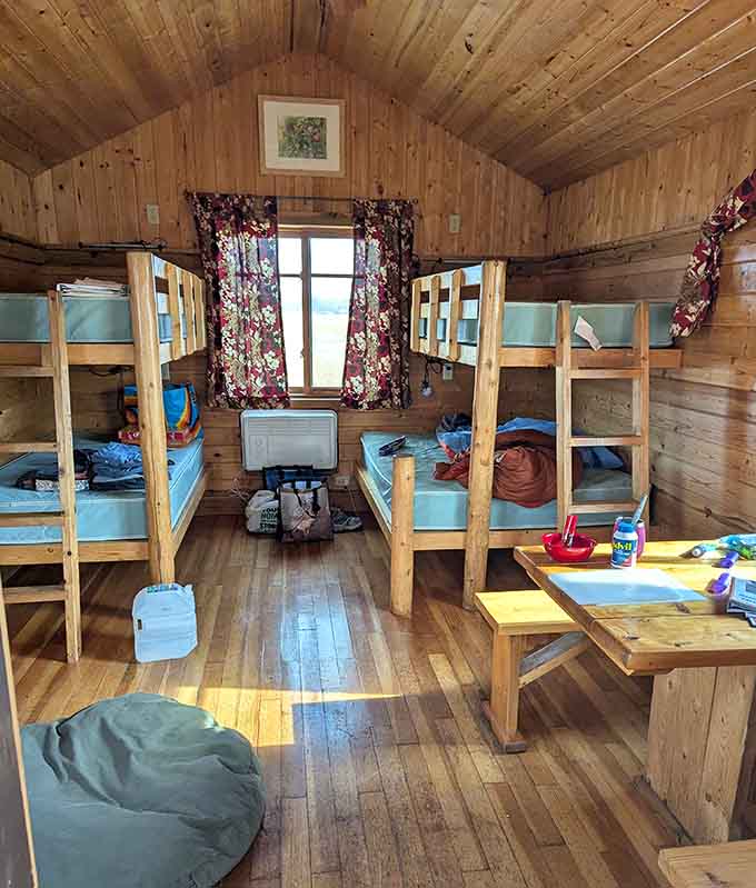 The cabin interior that redefines cozy, with bunk beds ready for tired adventurers and enough space for the whole crew to gather after a day of outdoor exploration.