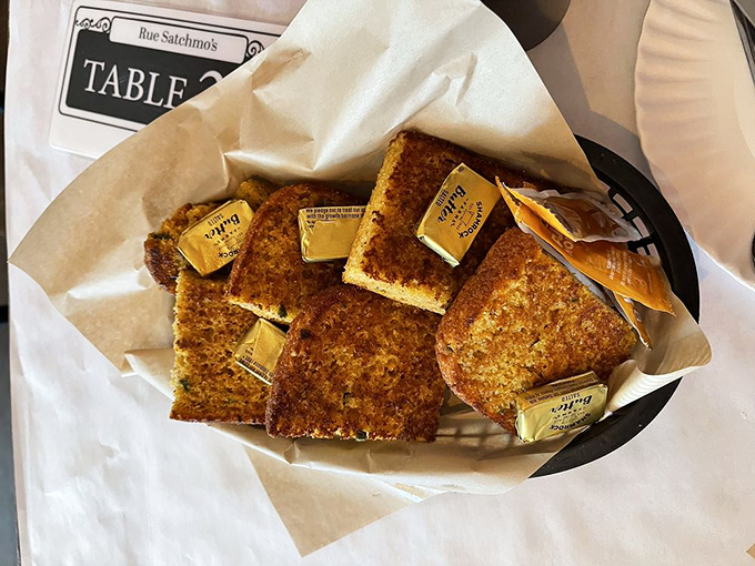 Cornbread squares arrive with butter melting into their golden surfaces like tiny pools of sunshine &ndash; resistance is futile.