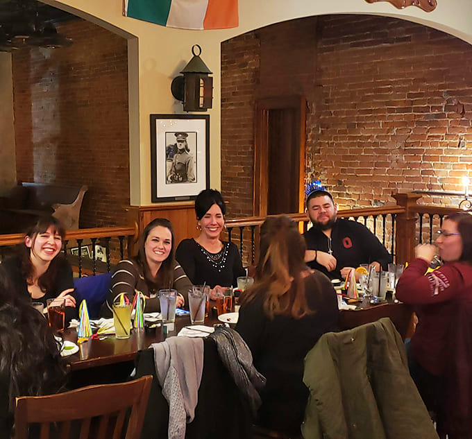 The dining room buzzes with conversation and laughter, where strangers become friends over shared appreciation for exceptional food and cold beverages.