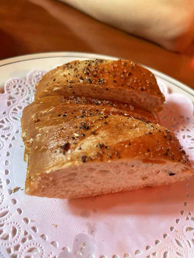 Warm homemade bread that arrives at your table like a delicious opening act, perfect for sauce-soaking duties later.