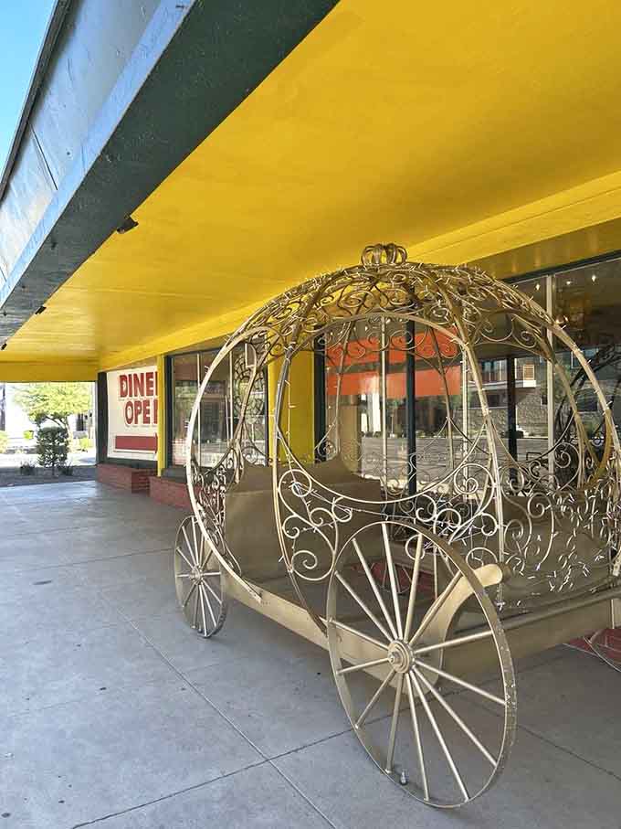 A fairytale carriage sits outside, because apparently even Cinderella needs a burger break between balls and glass slipper fittings.